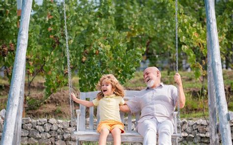 Premium Photo Excited Amazed Grandfather And Grandson Swinging On