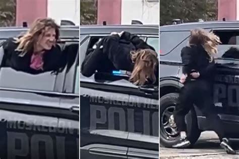 Handcuffed Woman Wiggles Out Of Police Custody Through Open Car Window
