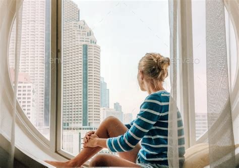 Woman Relaxing In The Round Shaped Window Looking Oking Outside Stock