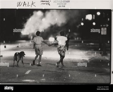 In The Eerie Glow Of A Burning Warehouse Two Women And A Dog