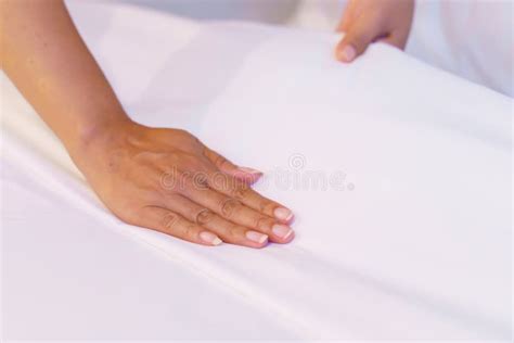 Female Hand Set Up White Bed Sheet In Bedroom Or Maid Hands Making Bed In A Hotel Room Stock