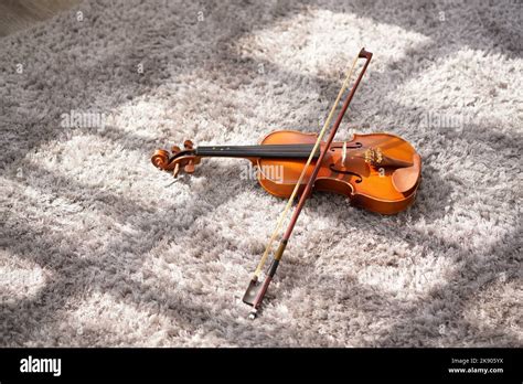 Violin Classic String Instrument With Bow On Light Brown Carpet Orchrestra Music Instrument Violin Classic String Instrument With Bow On Light Brown Carpet Orchrestra Music Instrument