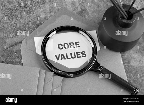 Core Values Ethics Concept Text Through A Magnifying Glass On A Piece Of Paper Sticking Out Of
