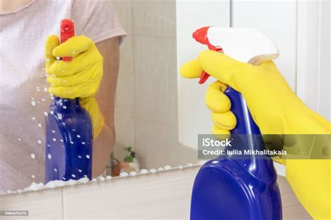 들고 청소 스프레이 병 및 유리 거울 표면에 뿌린 다는 파란색 노란색 고무 장갑에 인식할 수 없는 여자 세척 청소 하 고 닦는 개념 가사 집안일에 대한 스톡 사진 및 기타