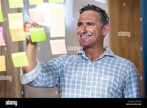 Man Writing On Sticky Notes Stock Photo Alamy