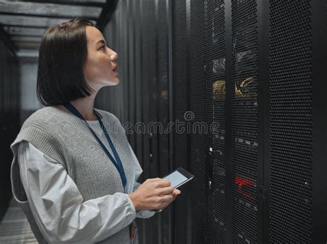 Tablet Server Room And Big Data With A Programmer Asian Woman At Work On A Computer Mainframe