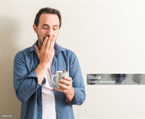 침묵 비밀 개념에에서 무서 워 하는 수석 남자 손으로 얼굴 커버 입에서 마시는 커피는 실수 두려움의 표현에 대 한 수치와 충격 가리기에 대한 스톡 사진 및 기타 이미지