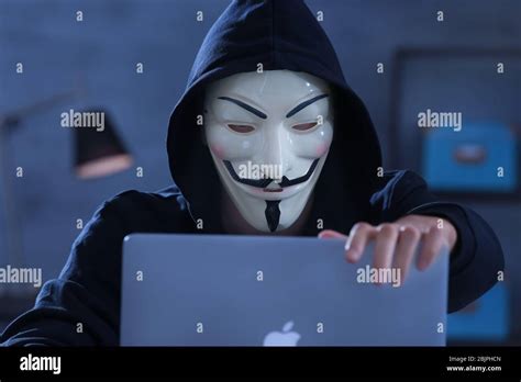 Hacker Anonymous Mask Using Laptop Hi Res Stock Photography And Images Alamy