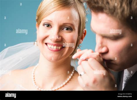 Happy Smiling Bride Groom Kissing Hand Of The Bride Blue Background Vertical Format Horizon