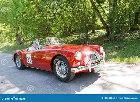 Red Color Mg Mga Twin Cam Classic Car From 1959 Driving On A Country