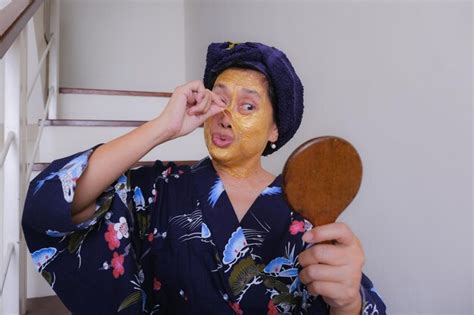 Premium Photo A Woman Looks At The Mirror As She Peels Off Her Beauty Mask Funny Silly Expression