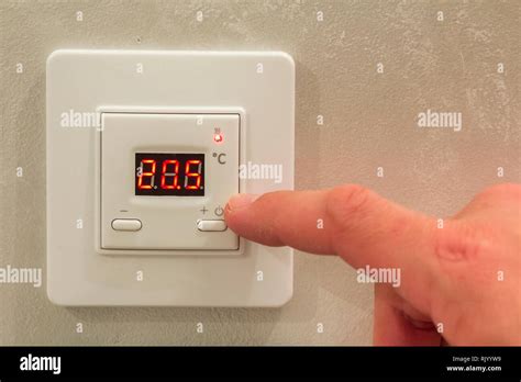 White Electronic Programmable Digital Thermostat On Light Wall Copy