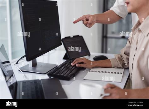 Two Developer Programmer Discussing To Checking Code On Monitor About