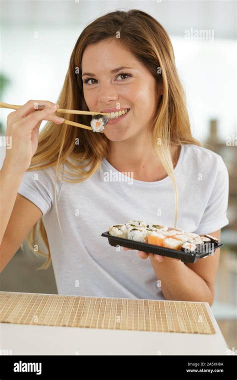 A Woman Eating Sushi Food Stock Photo Alamy