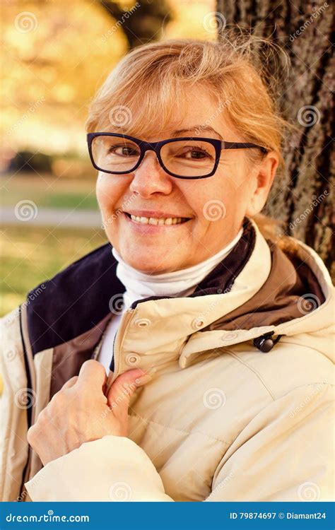 Cute Mature Woman Smiling Portrait On Black Background Royalty Free