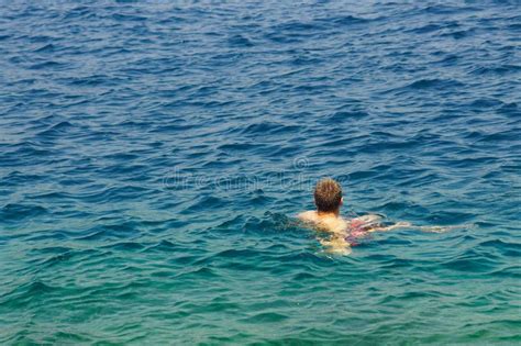 A Man Floating On His Back In A Beautifully Colored Sea Stock Image Image Of Tourist Water
