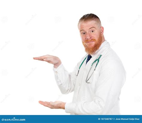 Redhead Doctor Wearing Medical Gown Holding Nothing On Palm As Copy Space Or Advertising Stock