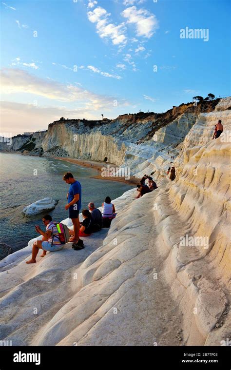 Tourists Watching The Sunset And Enjoying The Sea At The Scala Dei