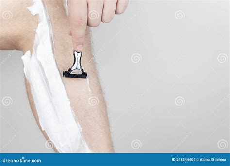A Man On A White Background Shaves His Legs Hairy Legs And Care For