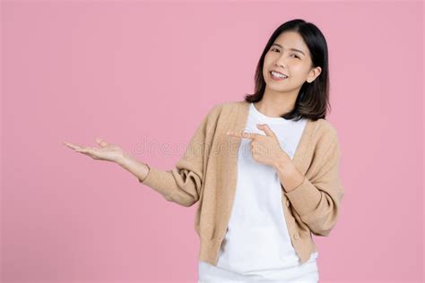 Portrait Asian Beautiful Young Woman Smiling Standing Pointing Finger Out On Pink Background