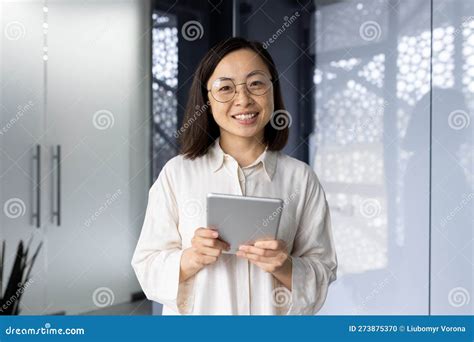 Portrait Of Successful Asian Female Programmer Inside Office Young Woman Smiling And Looking At