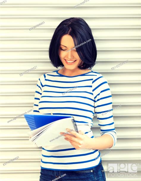 Picture Of Happy And Smiling Teenage Girl With Big Notepad Stock Photo Picture And Low Budget