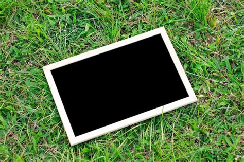 Premium Photo High Angle View Of Digital Tablet On Grassy Land