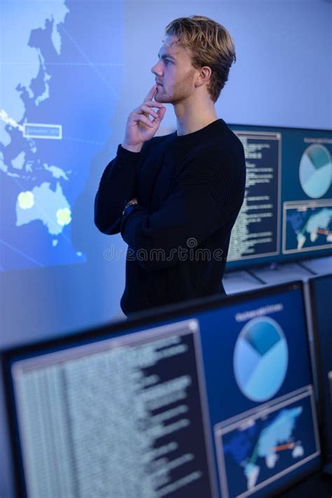 Thoughtful Cyber Security Control Center Operator Working Multiple