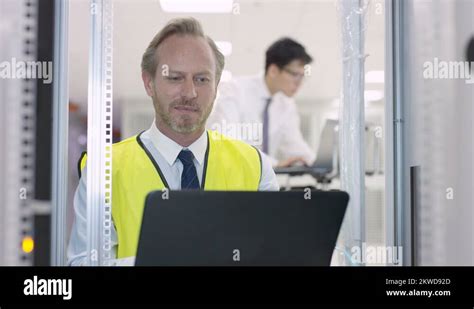 4k Portrait Smiling Engineer Carrying Out Checks In A Data Center