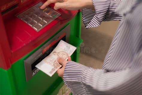 close up of woman hand entering pin pass code on atm bank machine