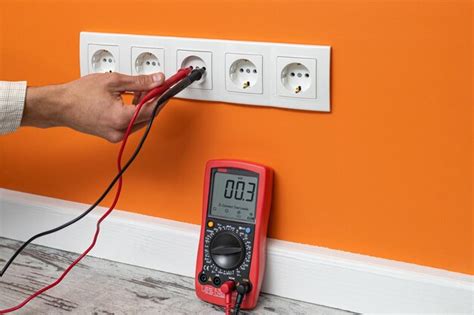 Premium Photo Man Checking The Voltage Of Electricity At A Home Outlet