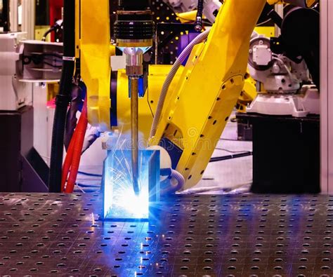 Automatic Welding Robot In Modern Factory In Operation Close Up Of Blue And Yellow Flames With