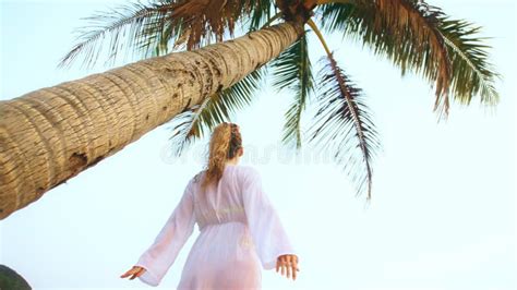 Woman Is Wetting Her Hair In A White Tunic On The Beach Near The Sea Blonde In Sunglasses