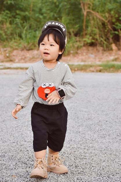Premium Photo Portrait Of Cute Girl Standing On Road