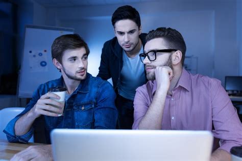 Premium Photo Committing Cybercrime Smart Handsome Male Hackers Working Together And Looking