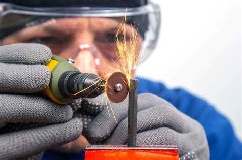 Premium Photo Man Mechanic Processes Metal With An Engraving Drill Locksmith Industry Metal