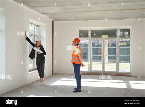 Female Designer Standing On Tips Of Her Toes And Putting Hand Against The Wall While Telling