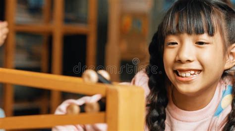 Closeup Of Cute Asian Girl Playing Car Toy With Friend At Play Room