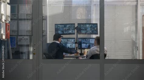Two Security Officers Control Cctv Cameras On Computers During Lunch
