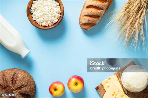 해피 Shavuot 인사말 카드 템플릿 플랫은 시리얼 빵 코티지 치즈 우유 한 병 밀 치즈 사과를 파란색 배경에 놓습니다 유대인의 종교적 휴일 개념 밀에 대한 스톡 사진 및