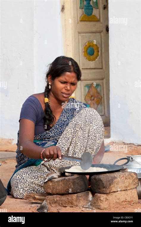Young Indian Wife In A Rural Village Making Chapati On An Open Fire