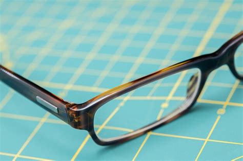 Premium Photo Close Up Of A Eyeglasses On Blue Background Copy Space Selective Focus