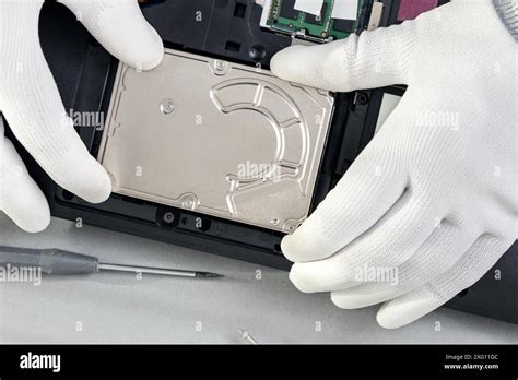 Technician Hands Removing An Old Mechanical Hard Disk From A Laptop Top View Stock Photo Alamy