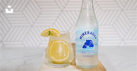 파란색과 흰색 라벨이 붙은 병은 투명한 음료수 유리 옆에 있습니다 사진 Unsplash의 무료 여름 이미지