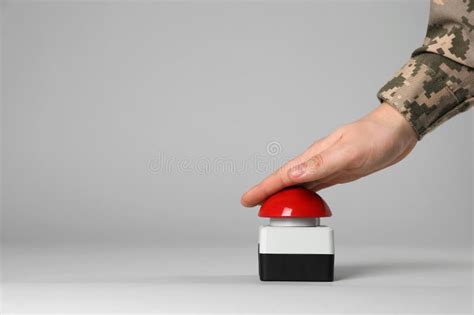 Serviceman Pressing Red Button Of Nuclear Weapon At Black Table Closeup War Concept Stock