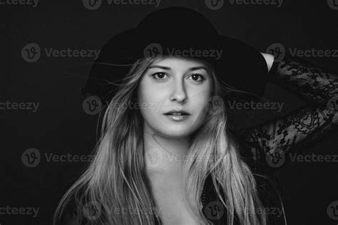 Beautiful Blonde Woman Wearing A Hat Artistic Film Portrait In Black