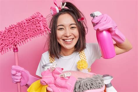 Premium Photo Positive Asian Housewife Smiles Toothily Enjoys Doing Housework Holds Cleaning