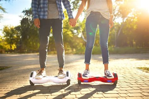 Premium Photo Legs Of Man And Woman Riding On The Hoverboard Together Outdoor Active Lifestyle