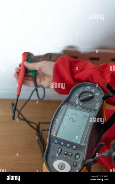 Electrician Tests Socket Voltage With A Specialized Device Ensuring