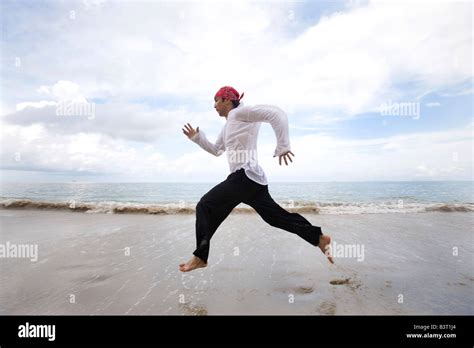 A Man Running Along The Beach Stock Photo Alamy
